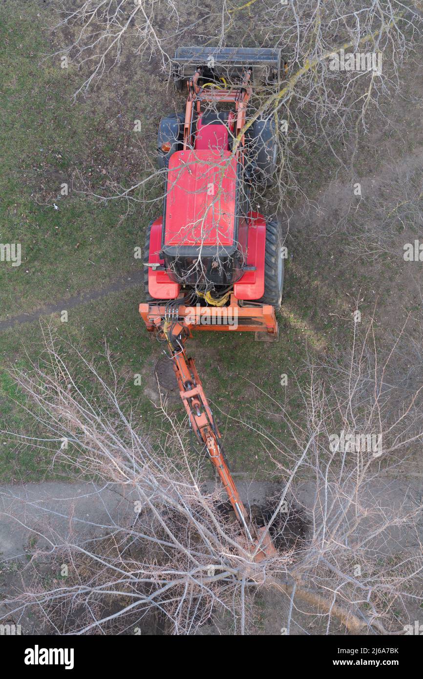 Excavator Tractor digs a hole, top view. The tractor is digging a hole ...