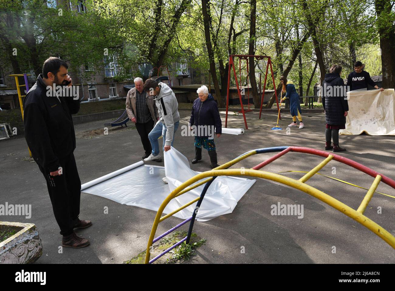 Residents prepare nylon to cover on their broken glass windows amid ...