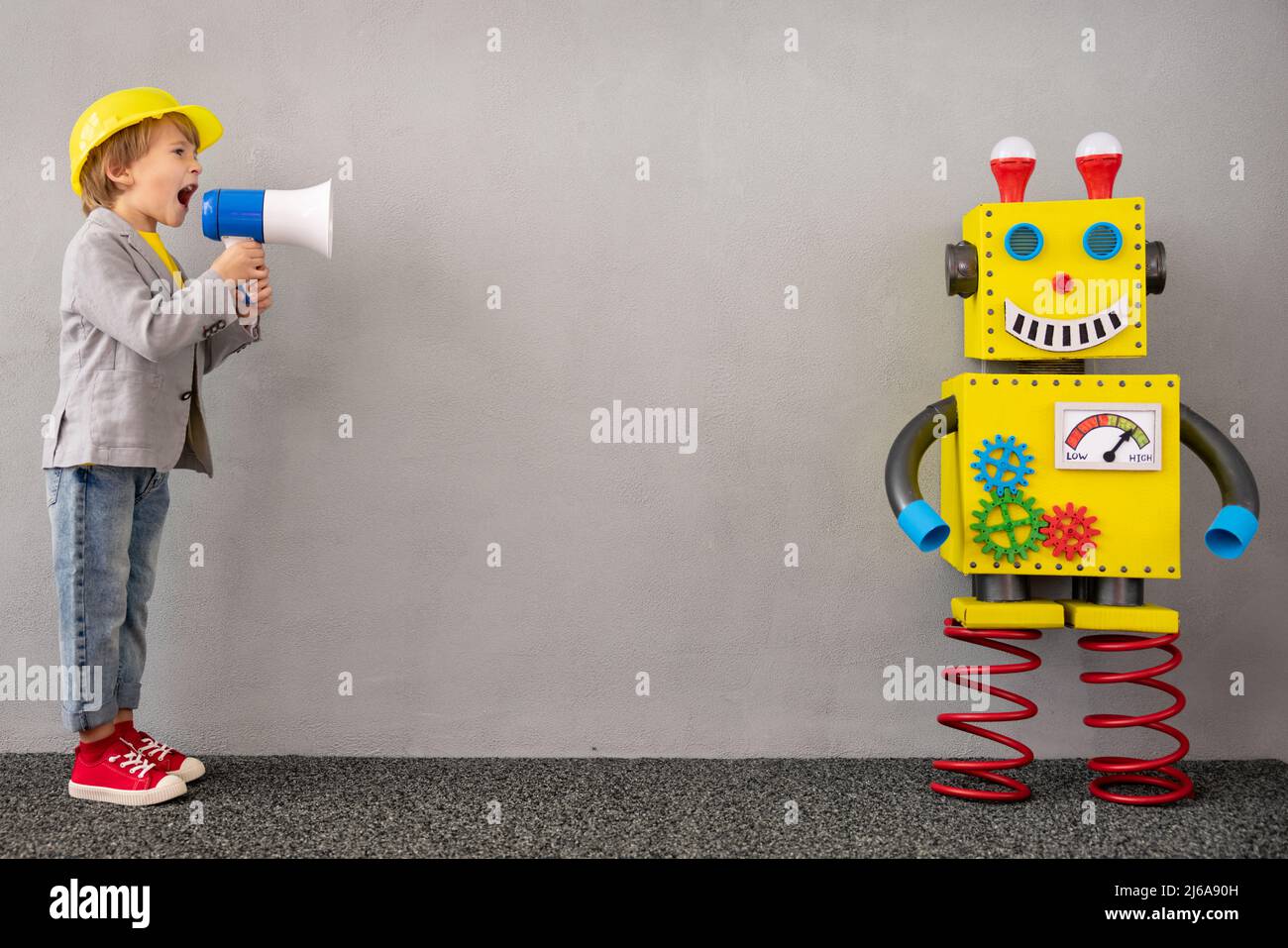 Happy child with robot. Funny kid playing at home. Boy shouting over ...