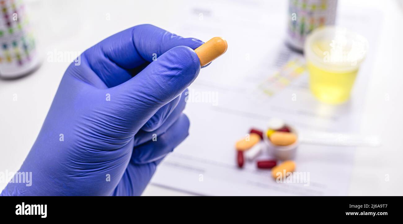 pharmacist's hand holding tablet for control Kidney infections ...