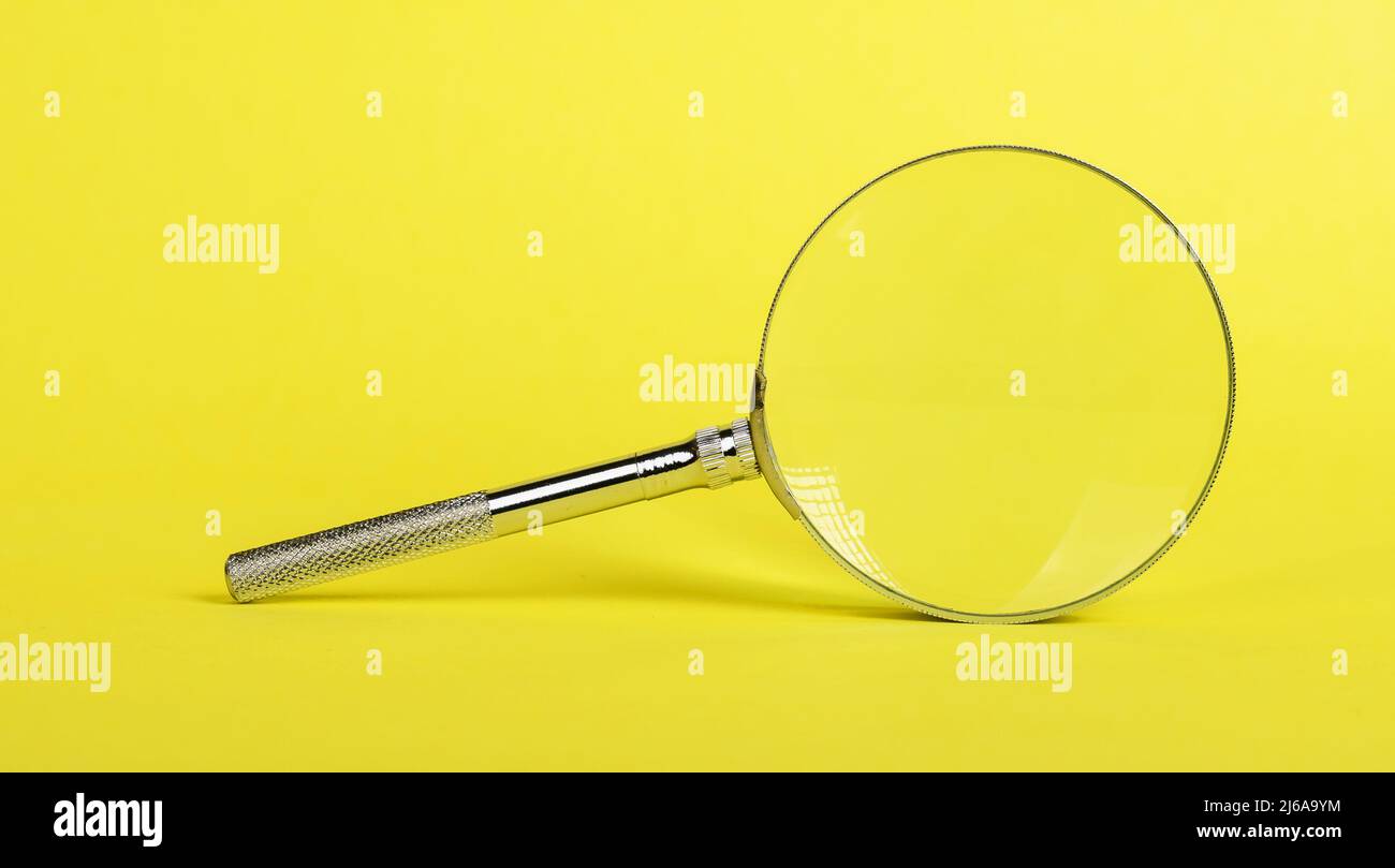 Magnifying glass on yellow background. Information search and analysis ...