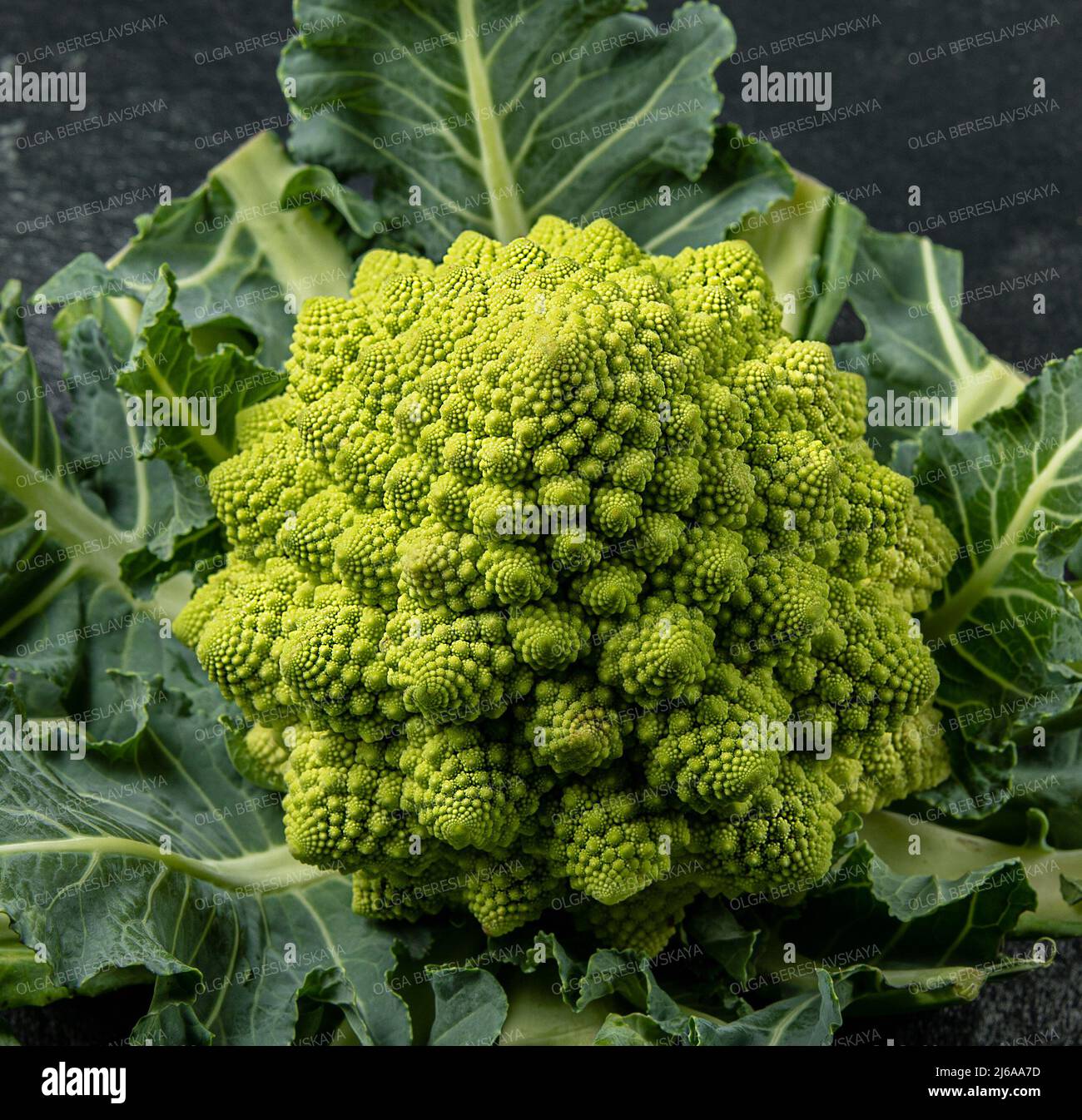Romanesco broccoli head on a dark stone surface, cabbage, close up ...