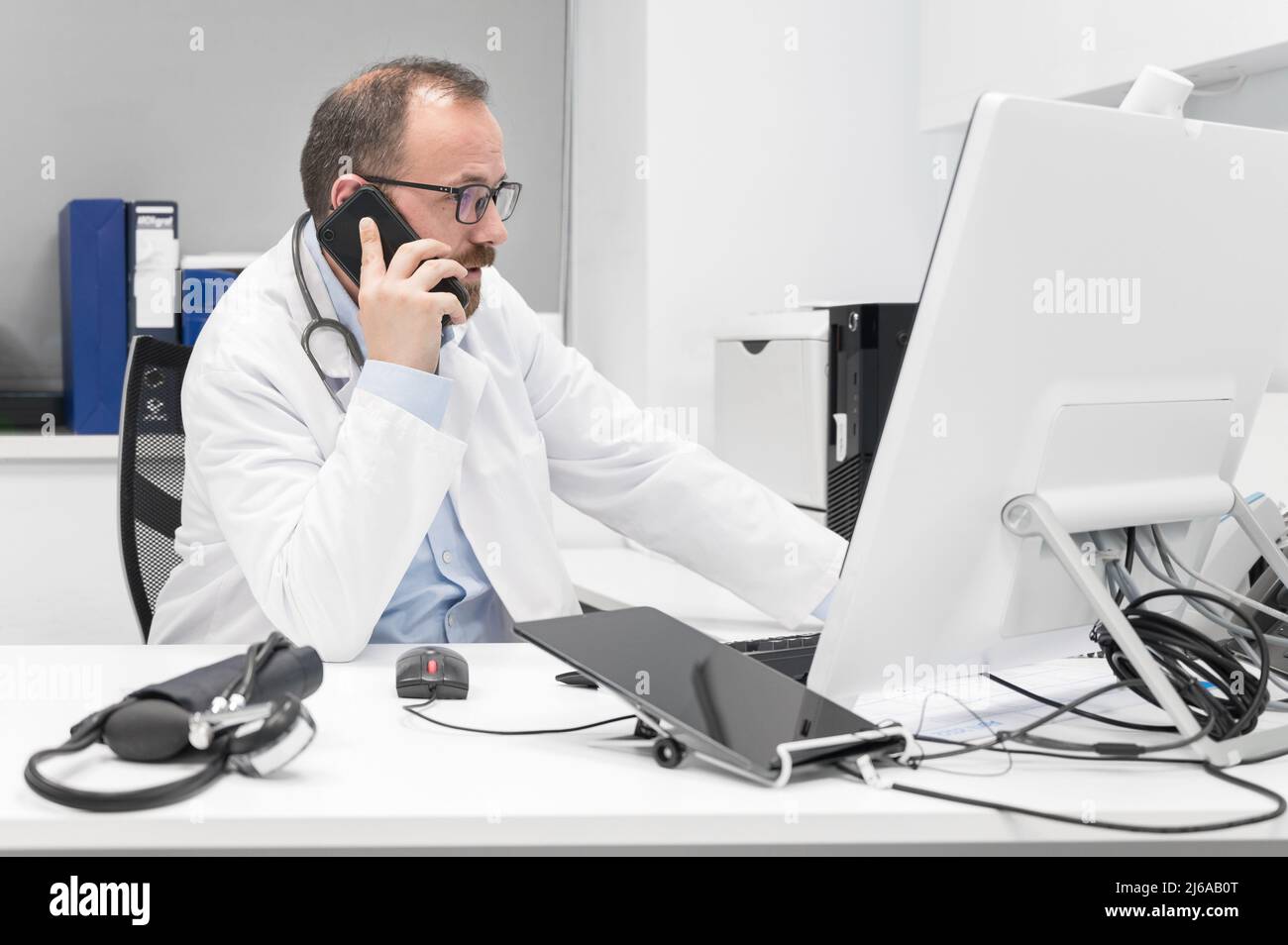 Doctor in office talking on phone. High quality photography Stock Photo ...