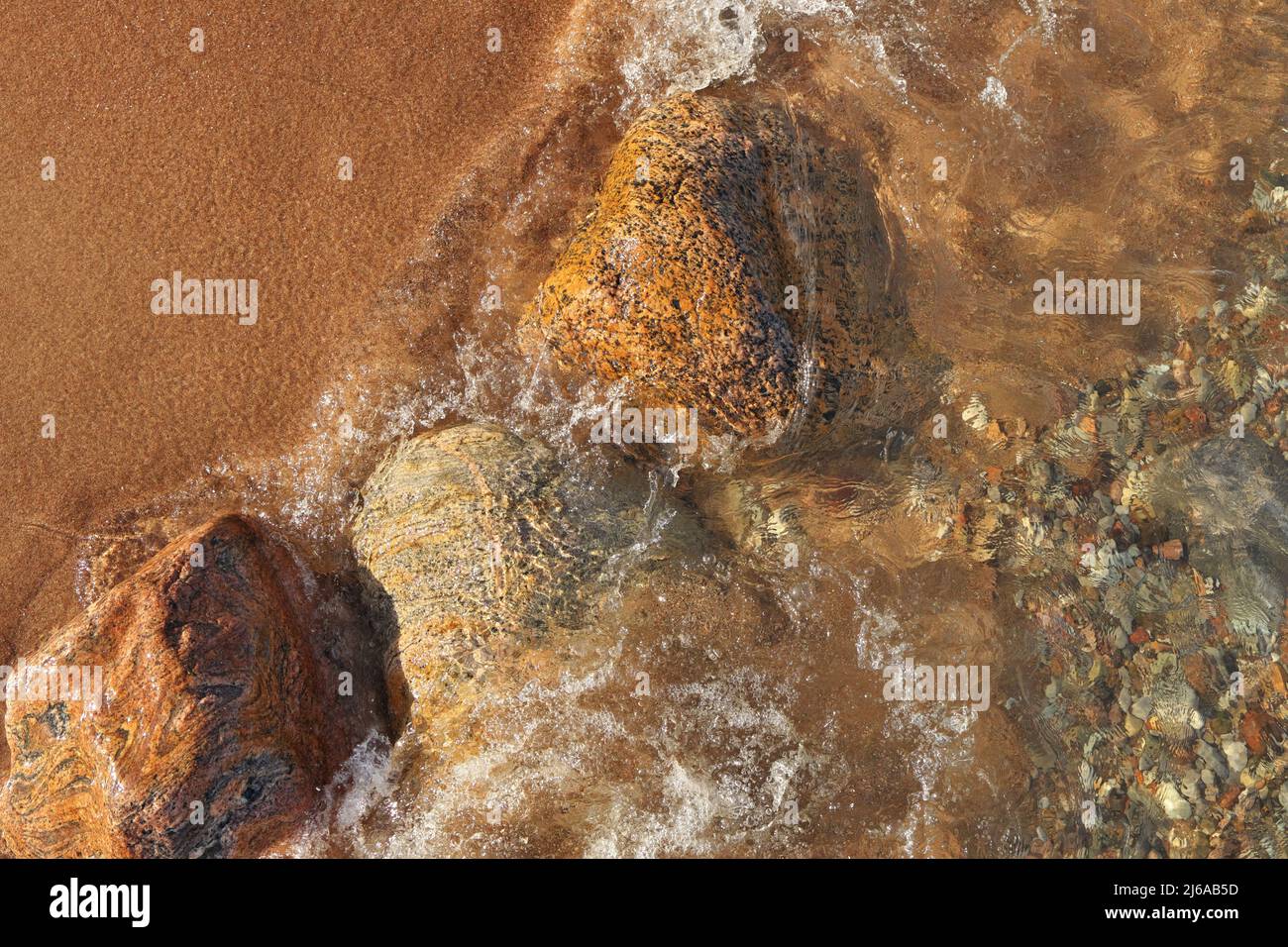 Directly Above Shot of Small Waves Rolling into Beach Dotted with ...