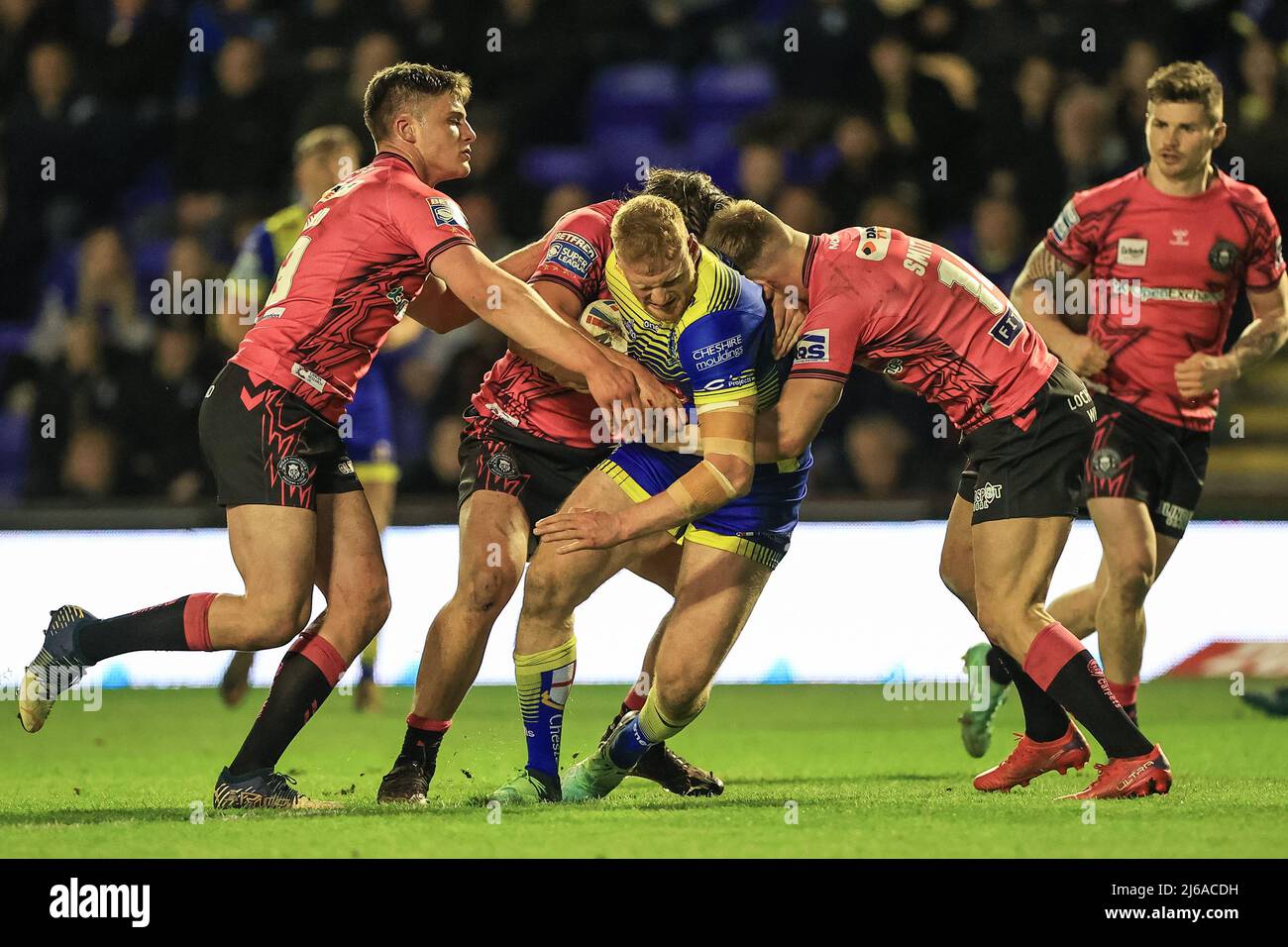 Joe Bullock #15 of Warrington Wolves barges into a Wigan wall Stock ...