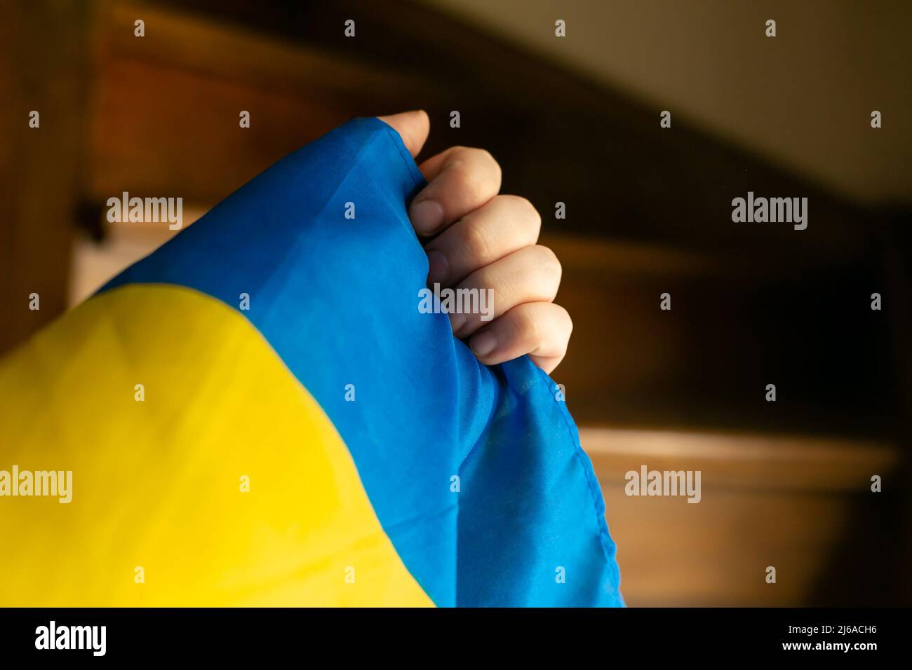 hand with small ukrainian flag wooden stairs background Stock Photo - Alamy