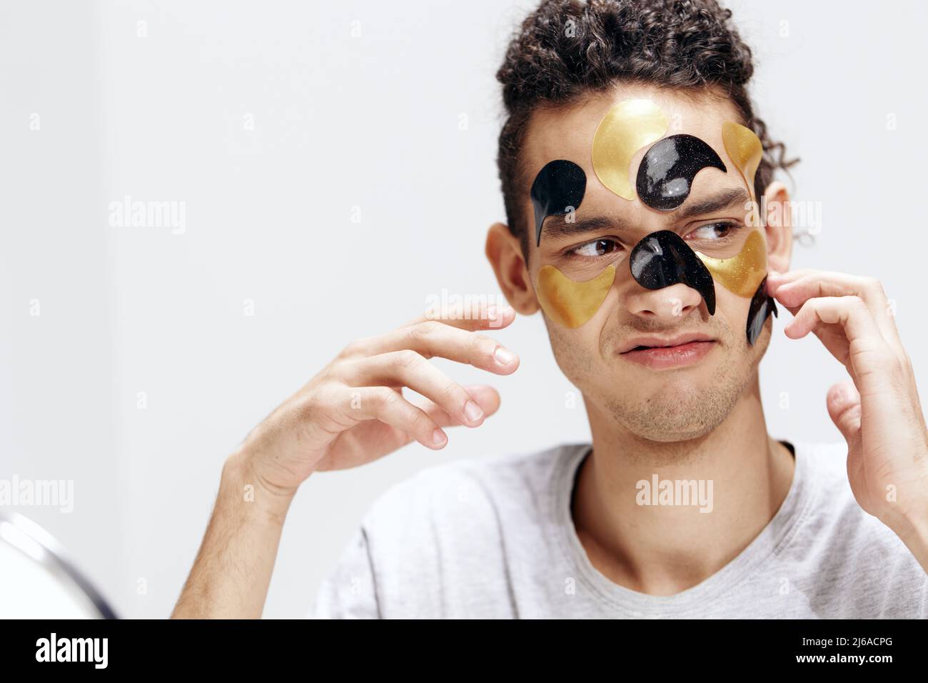 handsome guy many patches on the face touches face with hands skin care ...