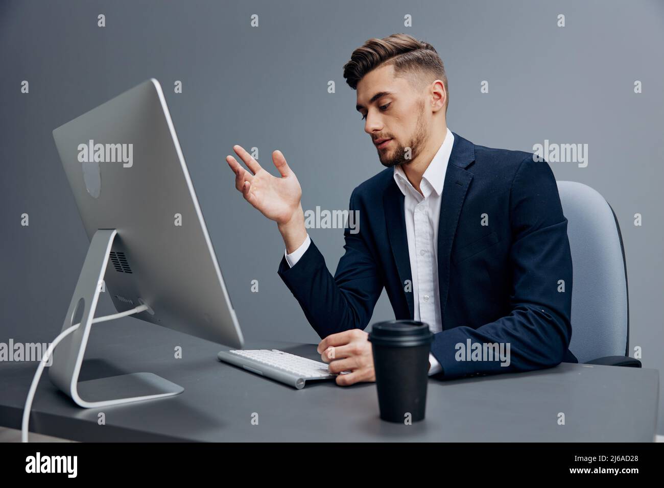 businessmen sitting at a desk in front of a computer isolated ...