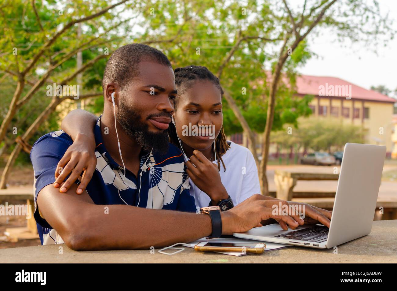 beautiful couple outdoor working on their laptop Stock Photo - Alamy