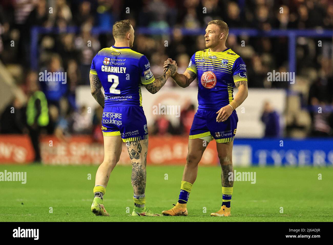 Josh Charnley #2 of Warrington Wolves and Oliver Holmes #12 of ...