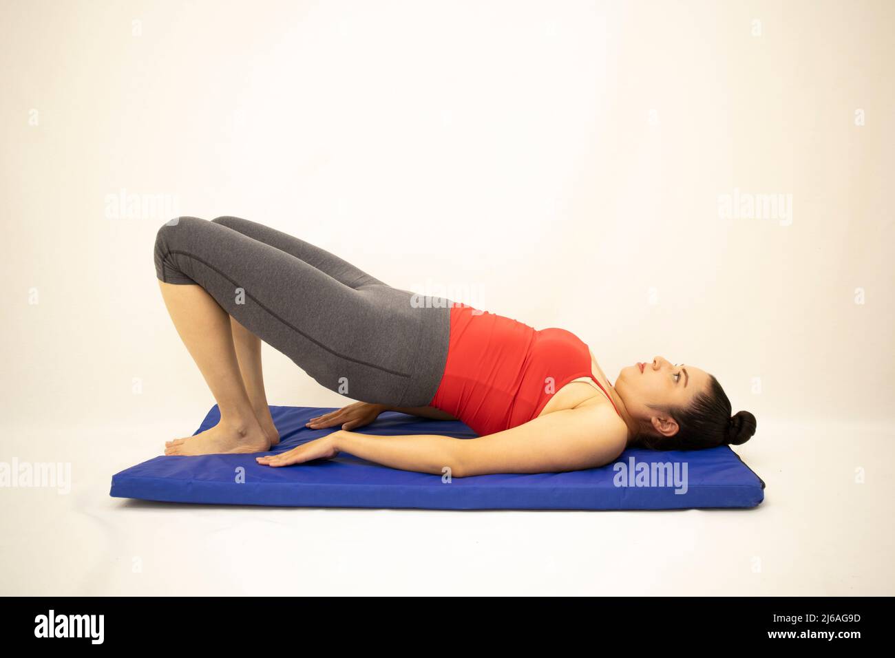 beautiful athletic white oriental woman working out in gray sportswear ...