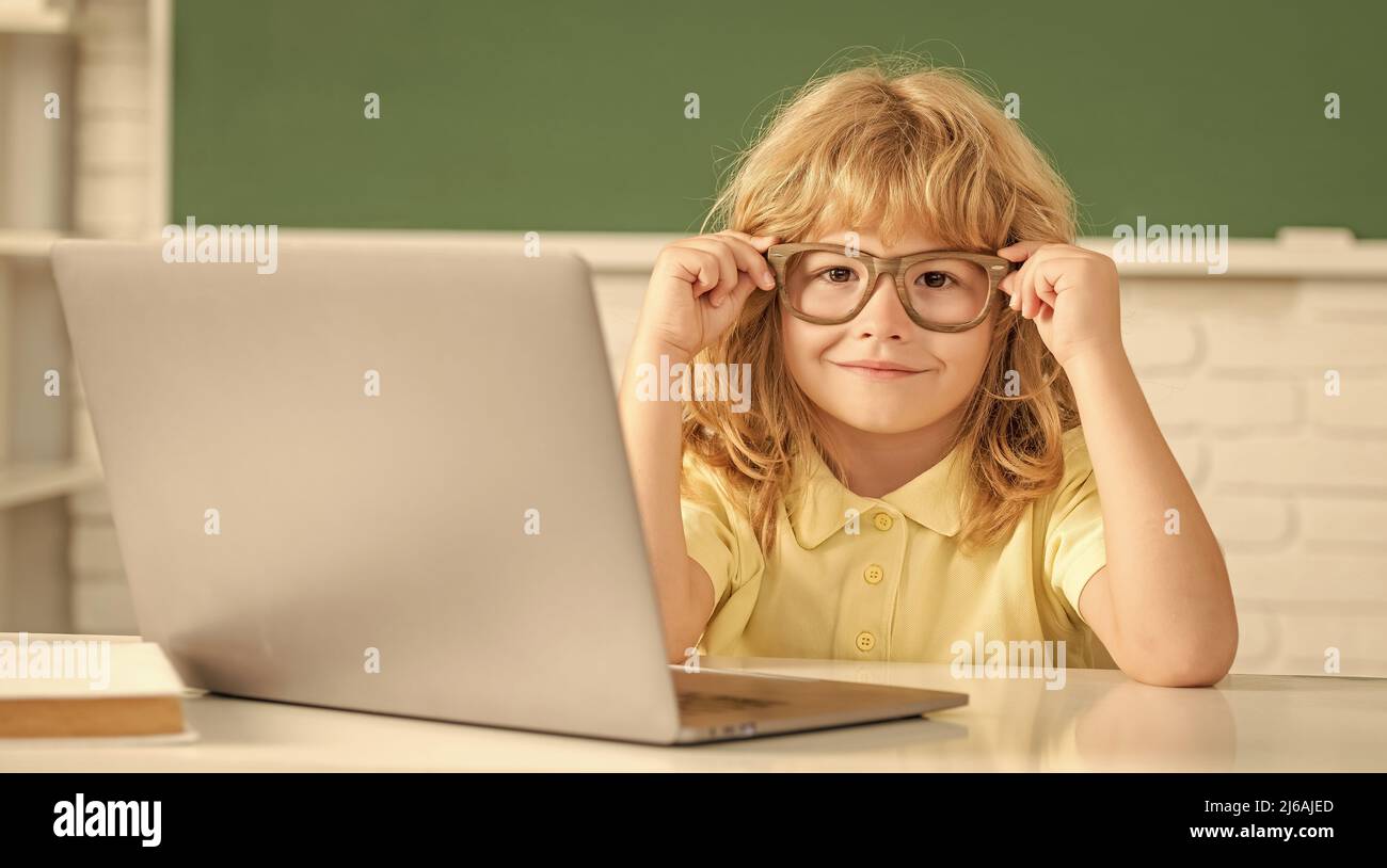 e-learning. child studying on computer. smiling teen boy in classroom ...