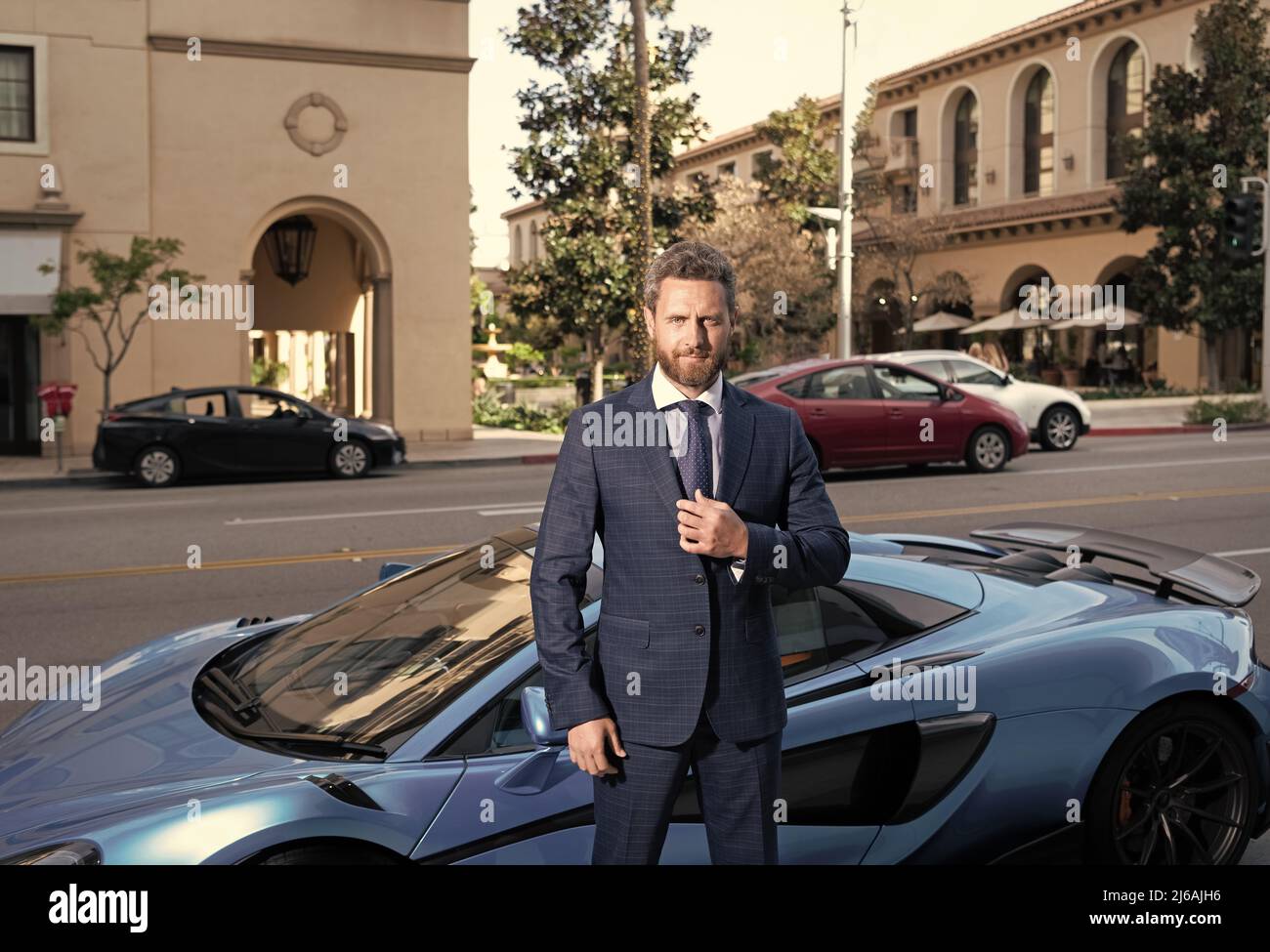 confident business man rent car. ceo stand by luxury automobile ...