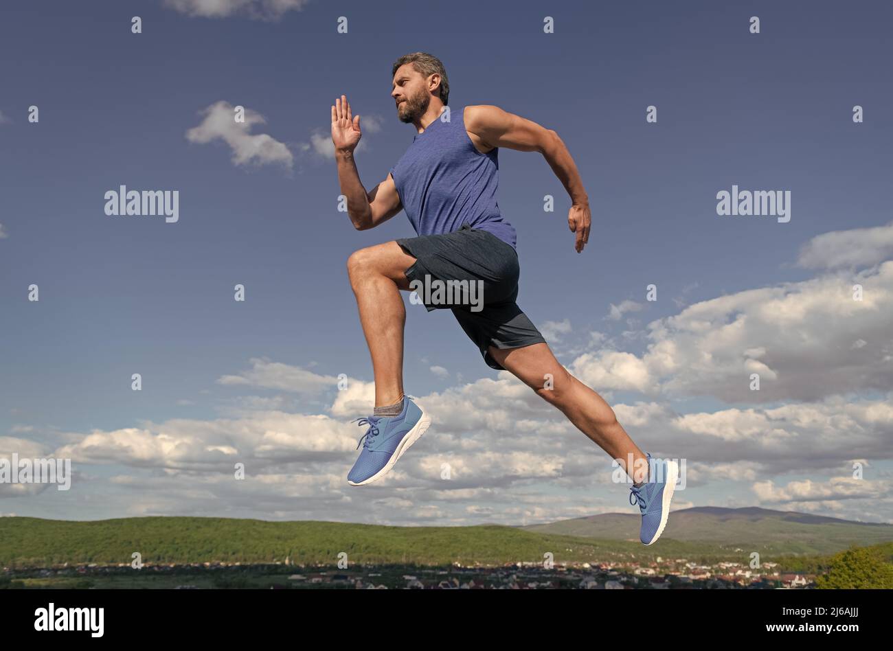 energetic man athlete with muscular body run in sportswear outdoor on ...