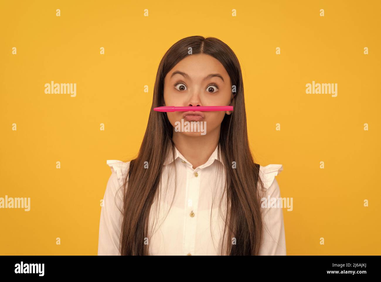 Fun at school. Funny girl hold pen as mustache. School education. Back ...