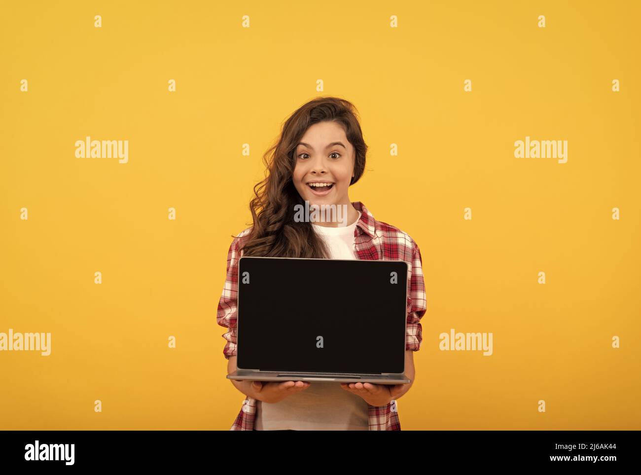 amazed smart child presenting laptop at school online lesson, school presentation Stock Photo ...