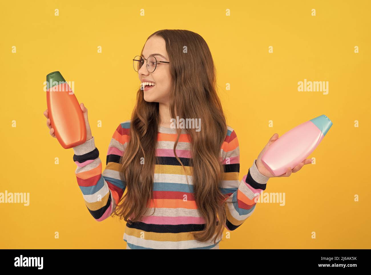 happy teen girl use shampoo bottle. child with hair conditioner. daily ...