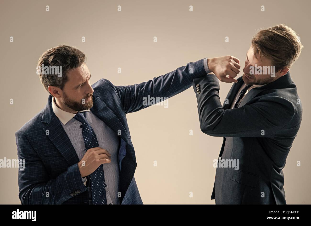 two angry businessmen punching in fight because of business competition ...