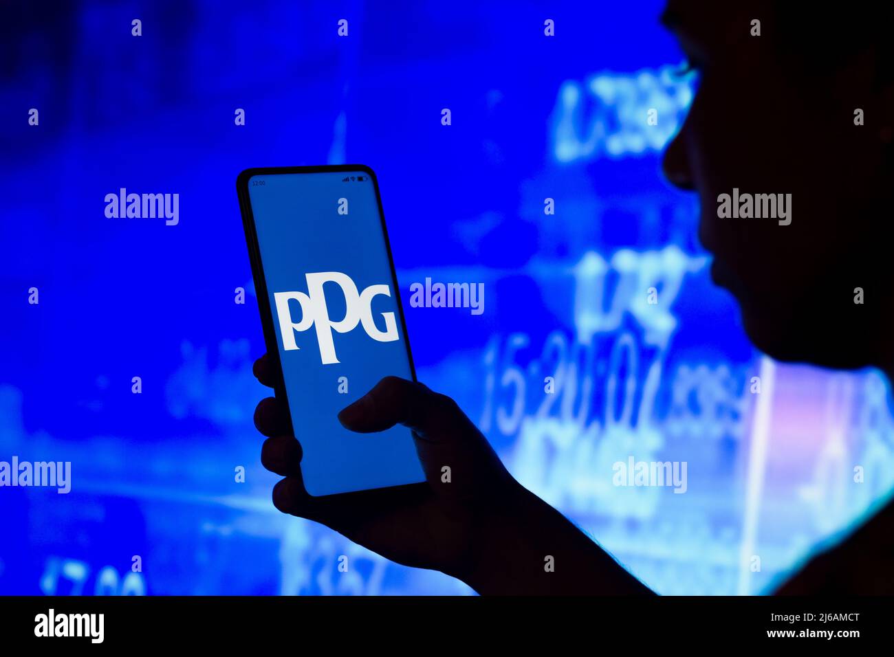 In this photo illustration, a silhouetted woman holds a smartphone with ...