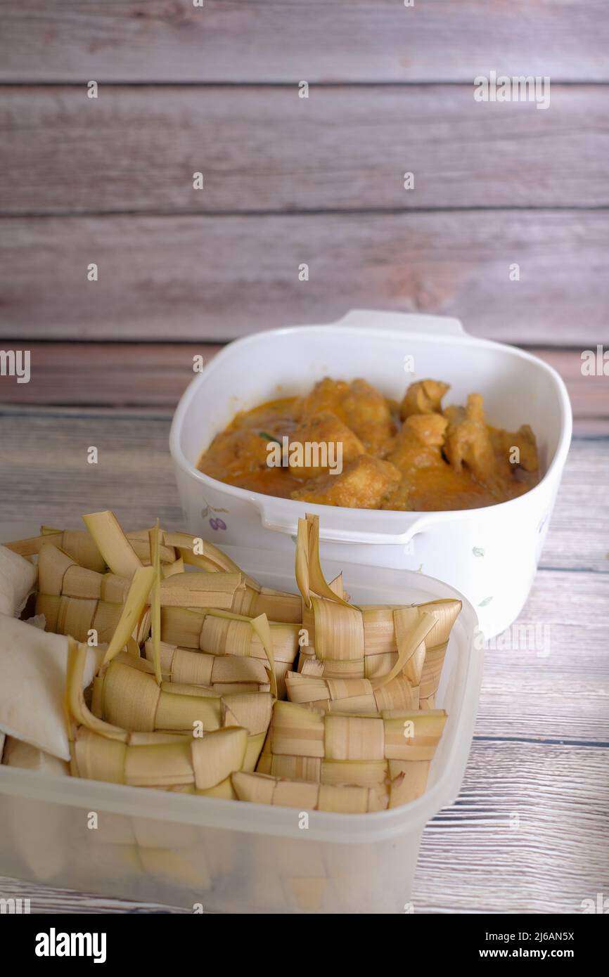 Ketupat (Rice Dumpling) and "Rendang" on wooden background. Ketupat is ...