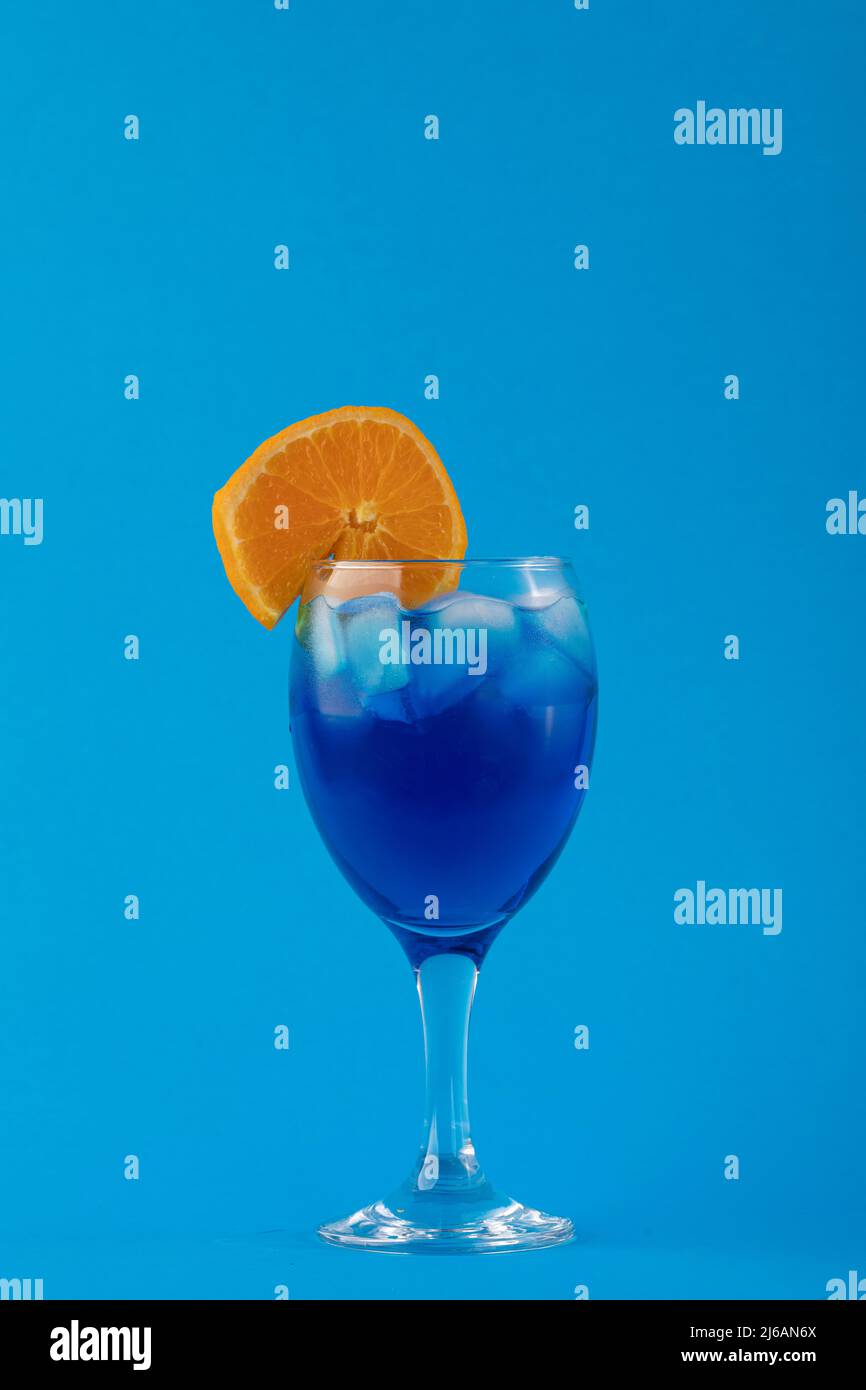 Blue Cocktail with Ice and Orange Slice Stock Photo - Alamy