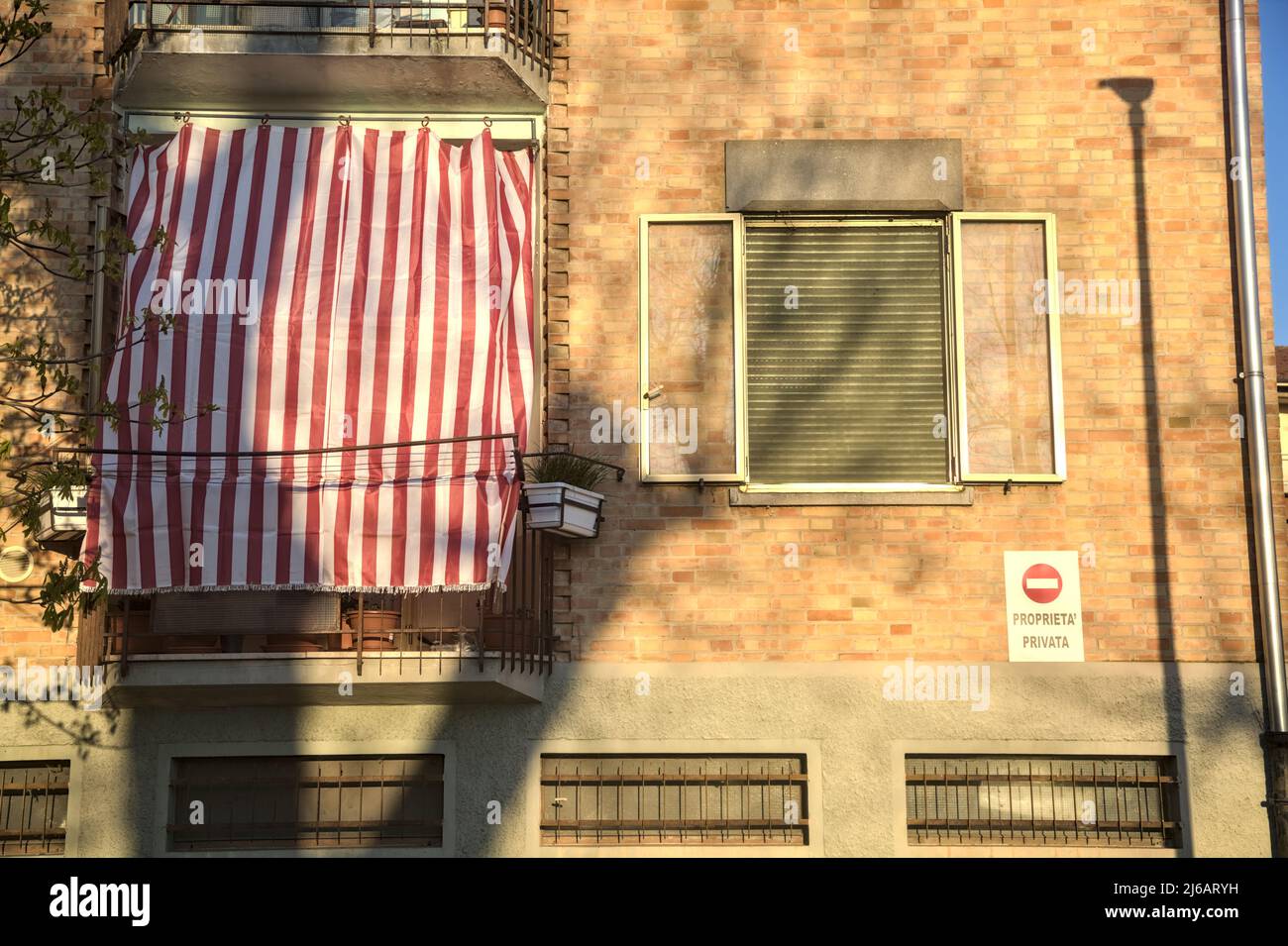 Balcony with awning and an open window of a facade at sunset Stock ...