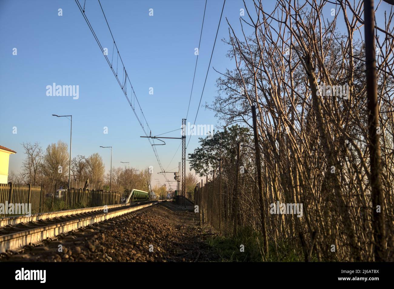 Railroad track on an embankment in a park at sunset Stock Photo - Alamy