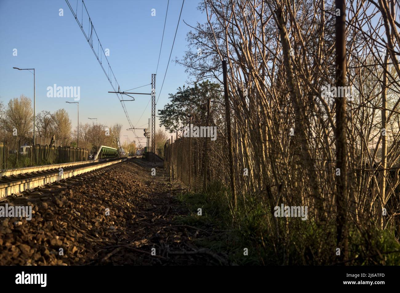 Railroad track on an embankment in a park at sunset Stock Photo - Alamy