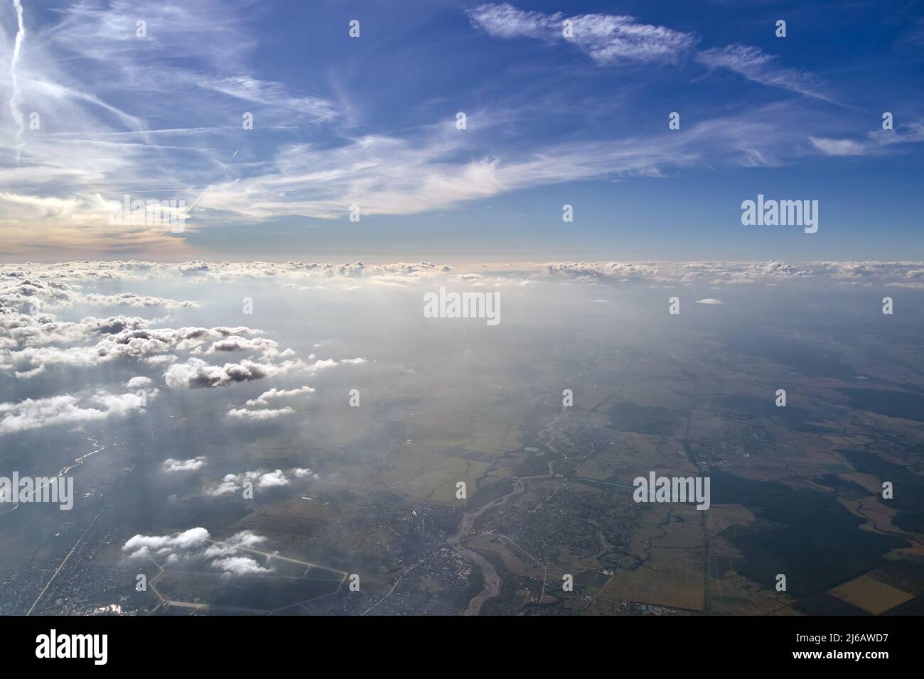 Aerial view from airplane window at high altitude of earth covered with ...