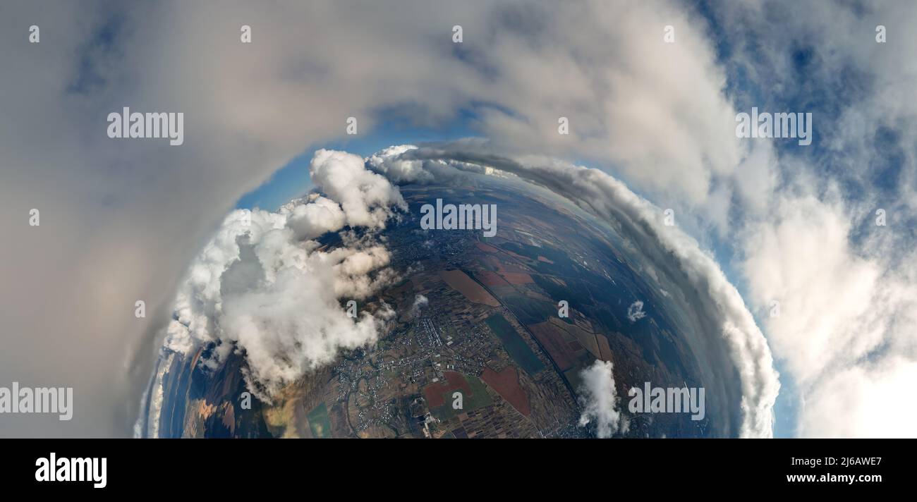 Aerial view from high altitude of little planet with distant city ...