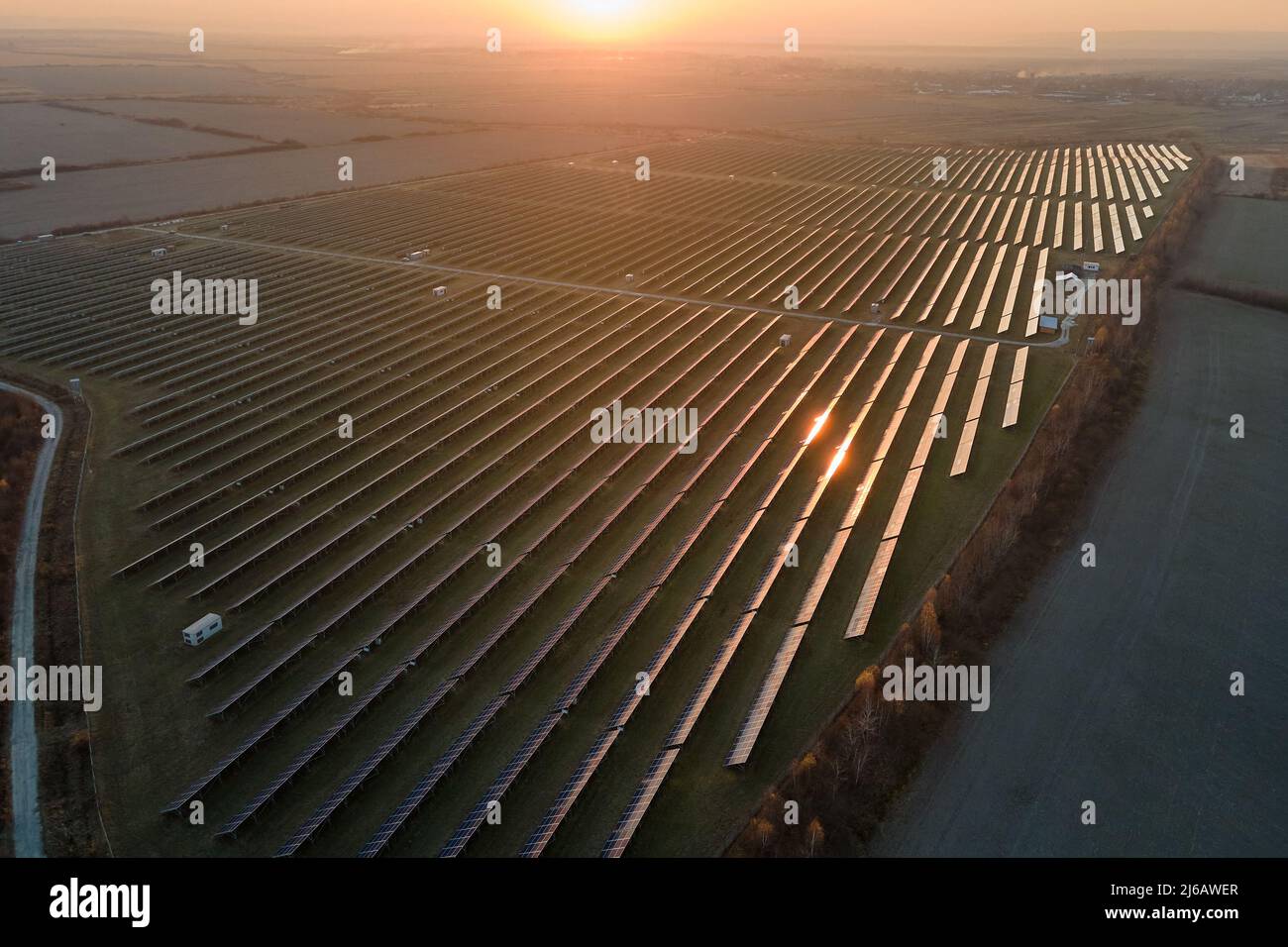 Aerial view of big sustainable electric power plant with many rows of ...