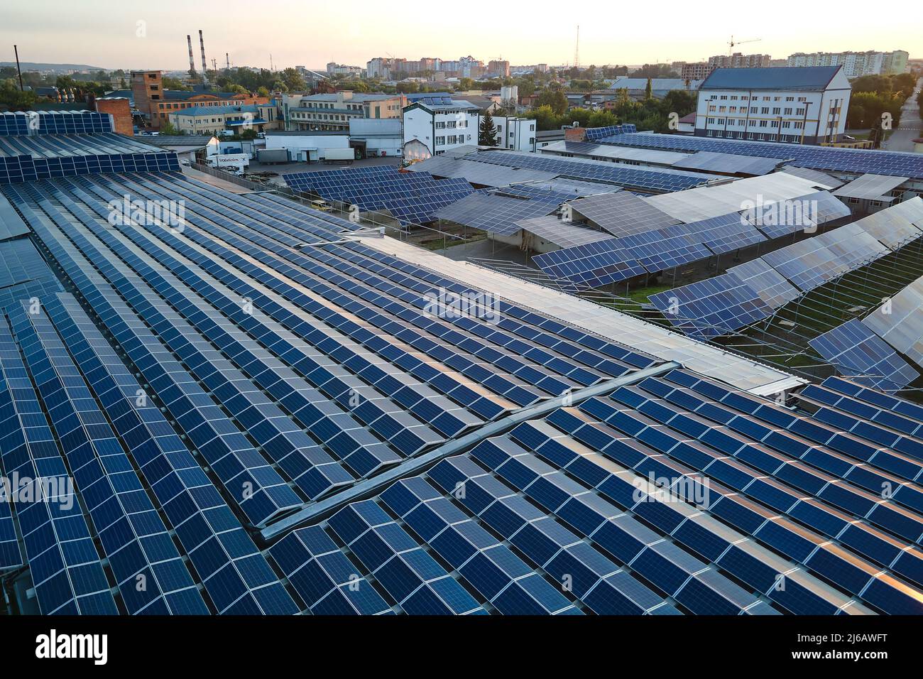 Aerial view of blue photovoltaic solar panels mounted on industrial ...