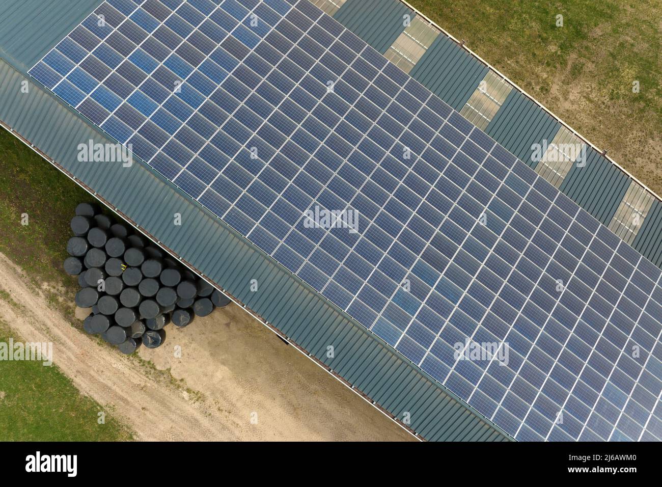 Aerial view of farm building with photovoltaic solar panels mounted on ...