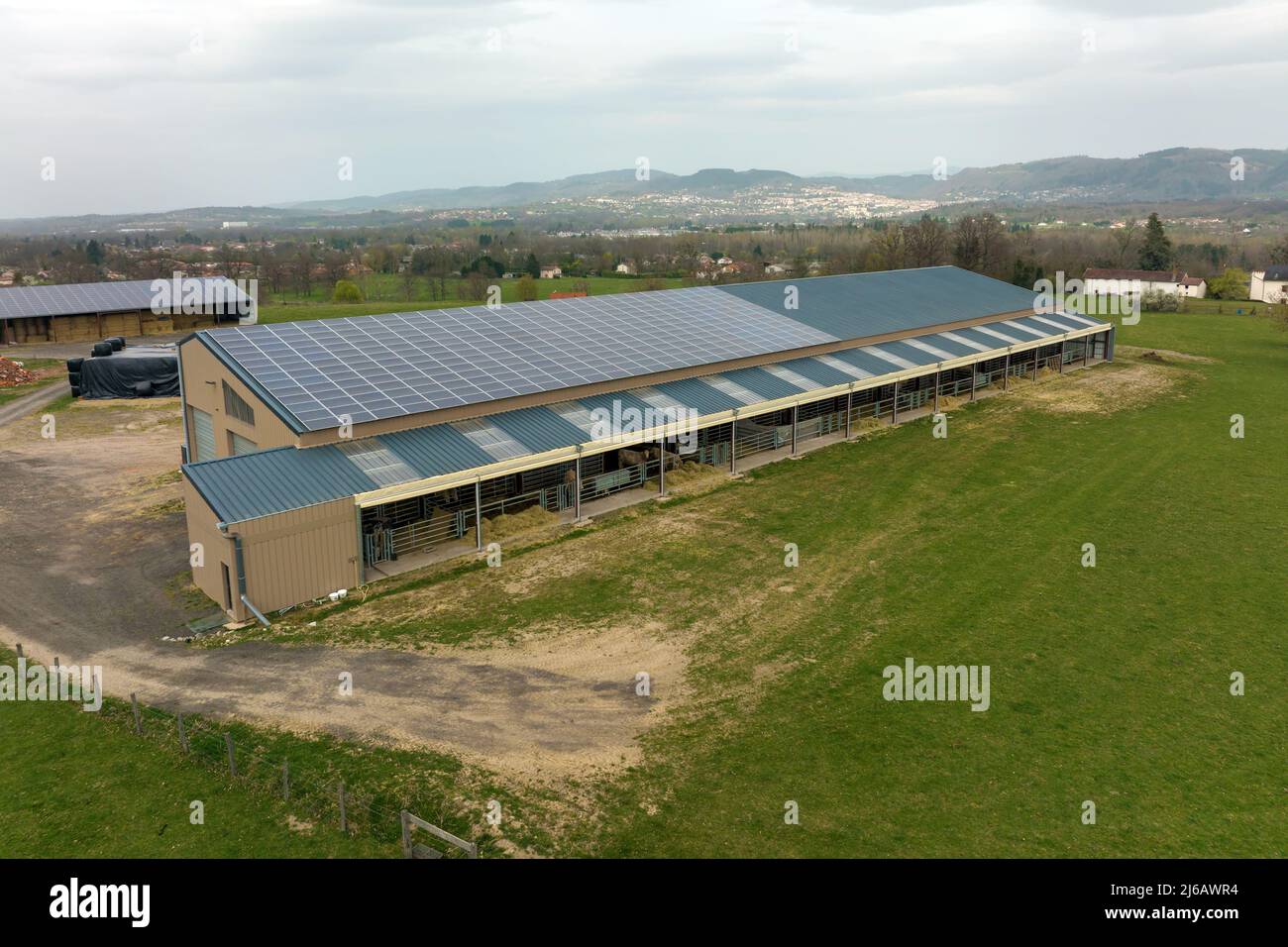 Aerial view of farm building with photovoltaic solar panels mounted on ...