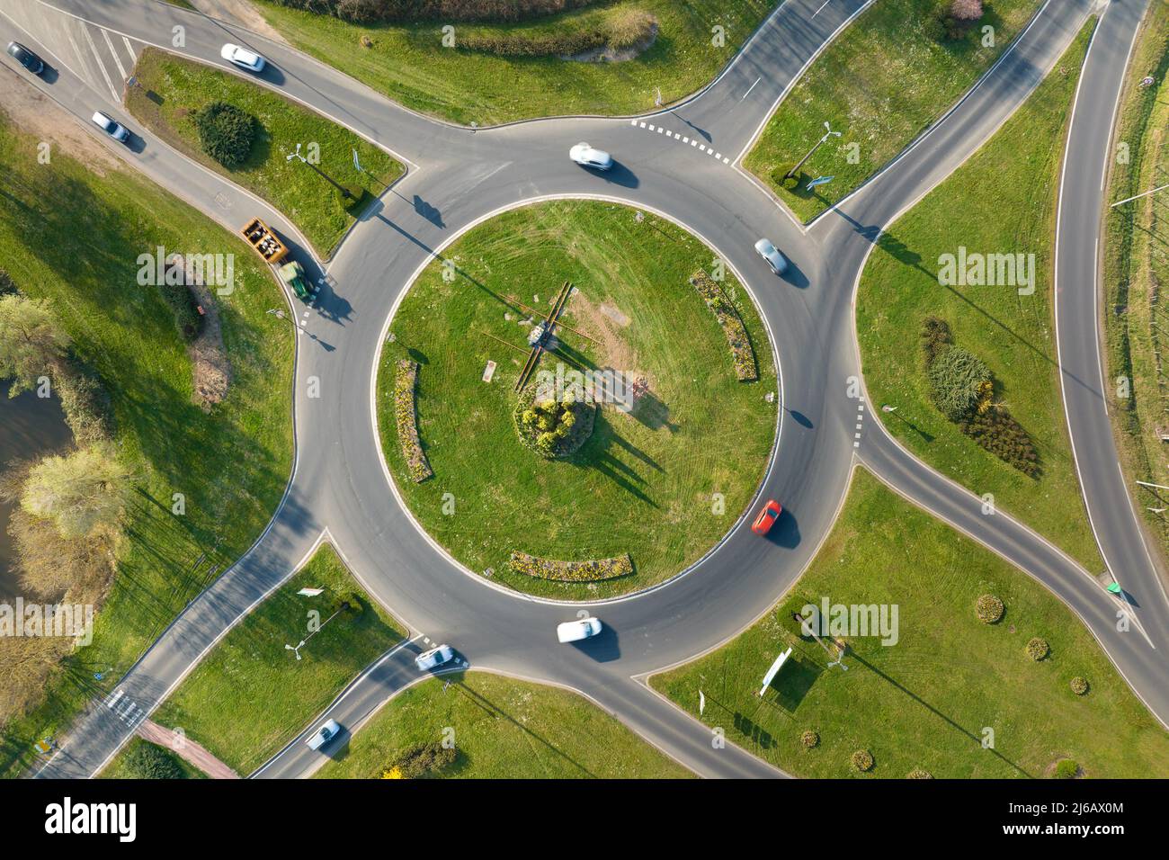 Aerial view of road roundabout intersection with moving heavy traffic ...