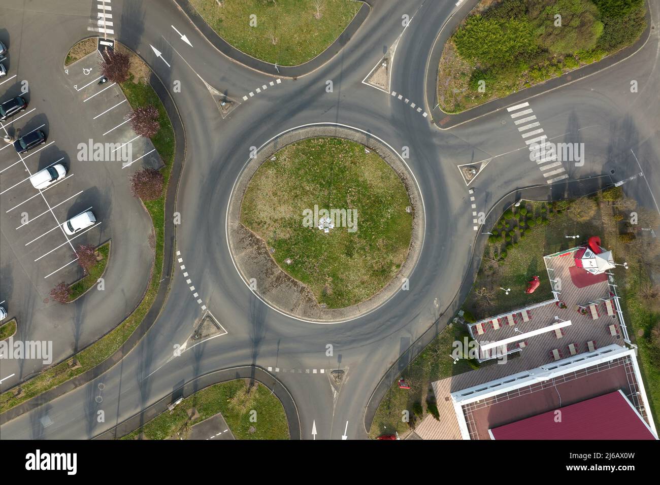Aerial view of road roundabout intersection with fast moving heavy ...
