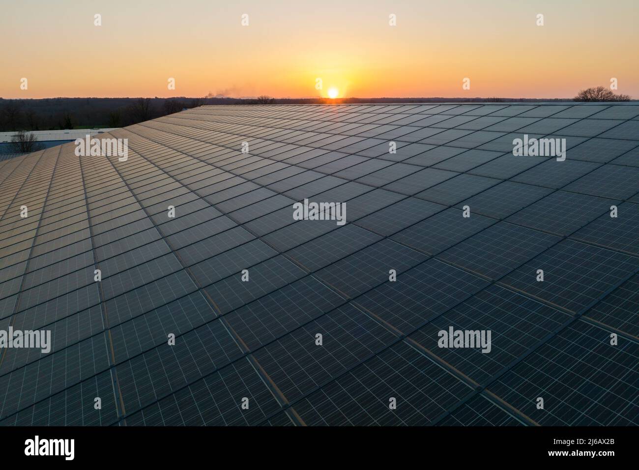 Blue photovoltaic solar panels mounted on building roof for producing ...