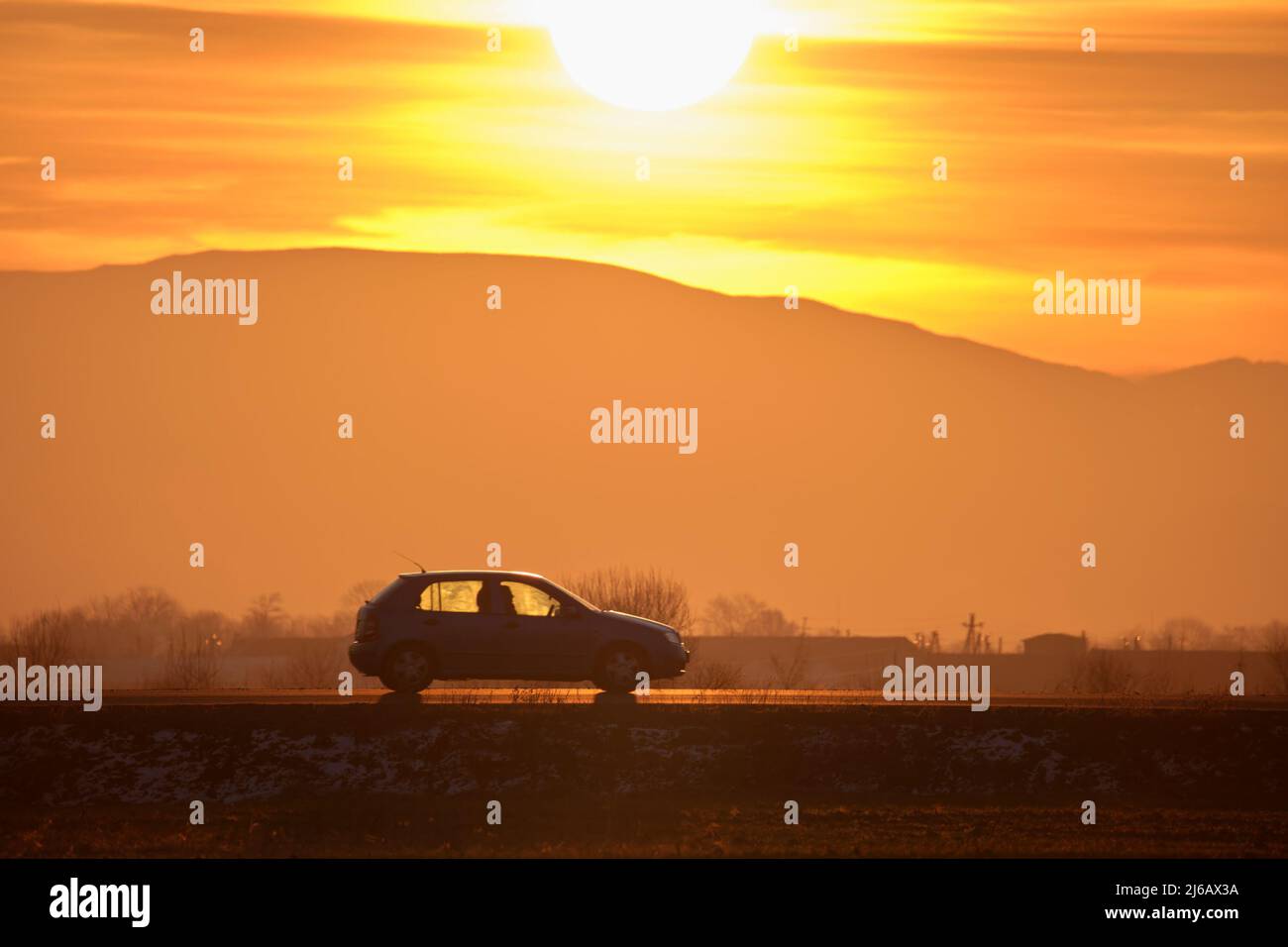 Car driving fast on intercity road at sunset. Highway traffic in ...