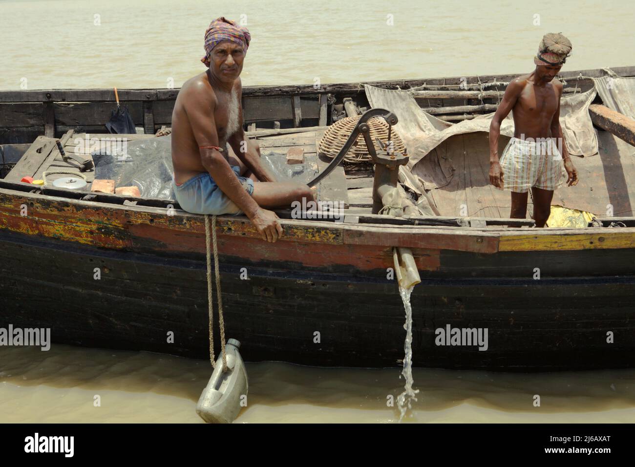 Portrait of boat crews as they are pausing from transporting pieces of ...