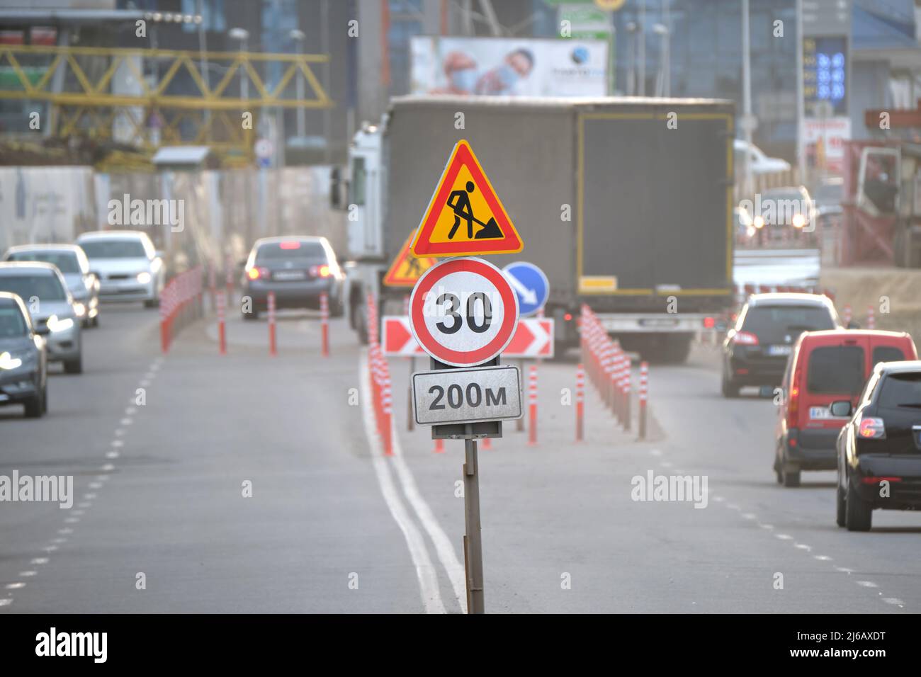 Roadworks warning traffic signs of construction work on city street and ...