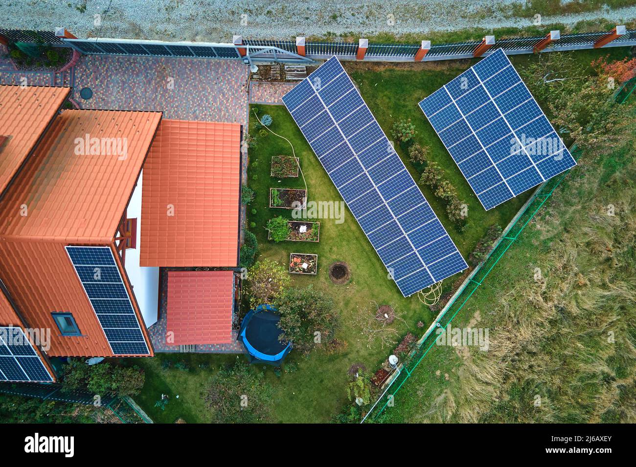 Solar photovoltaic panels mounted on stand-alone frame on backyard ...