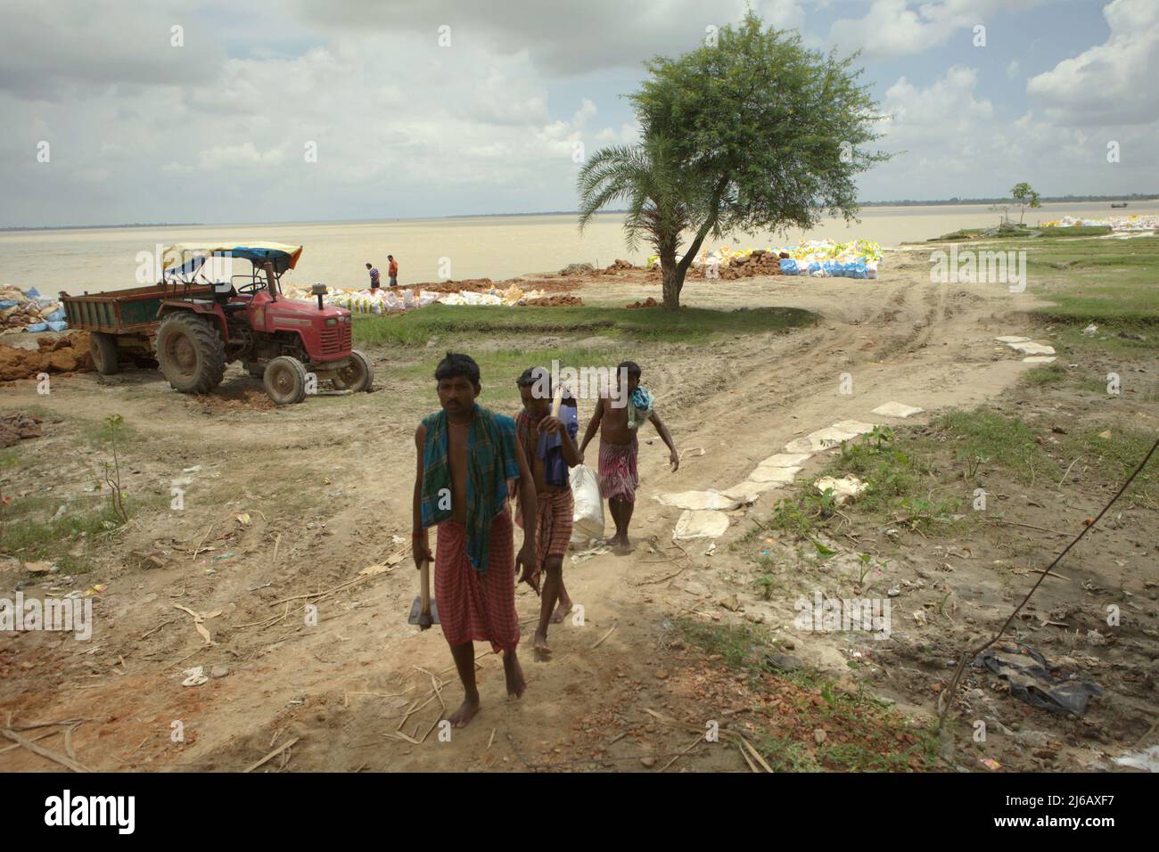 A group of workers walking for lunch, during a river erosion control ...