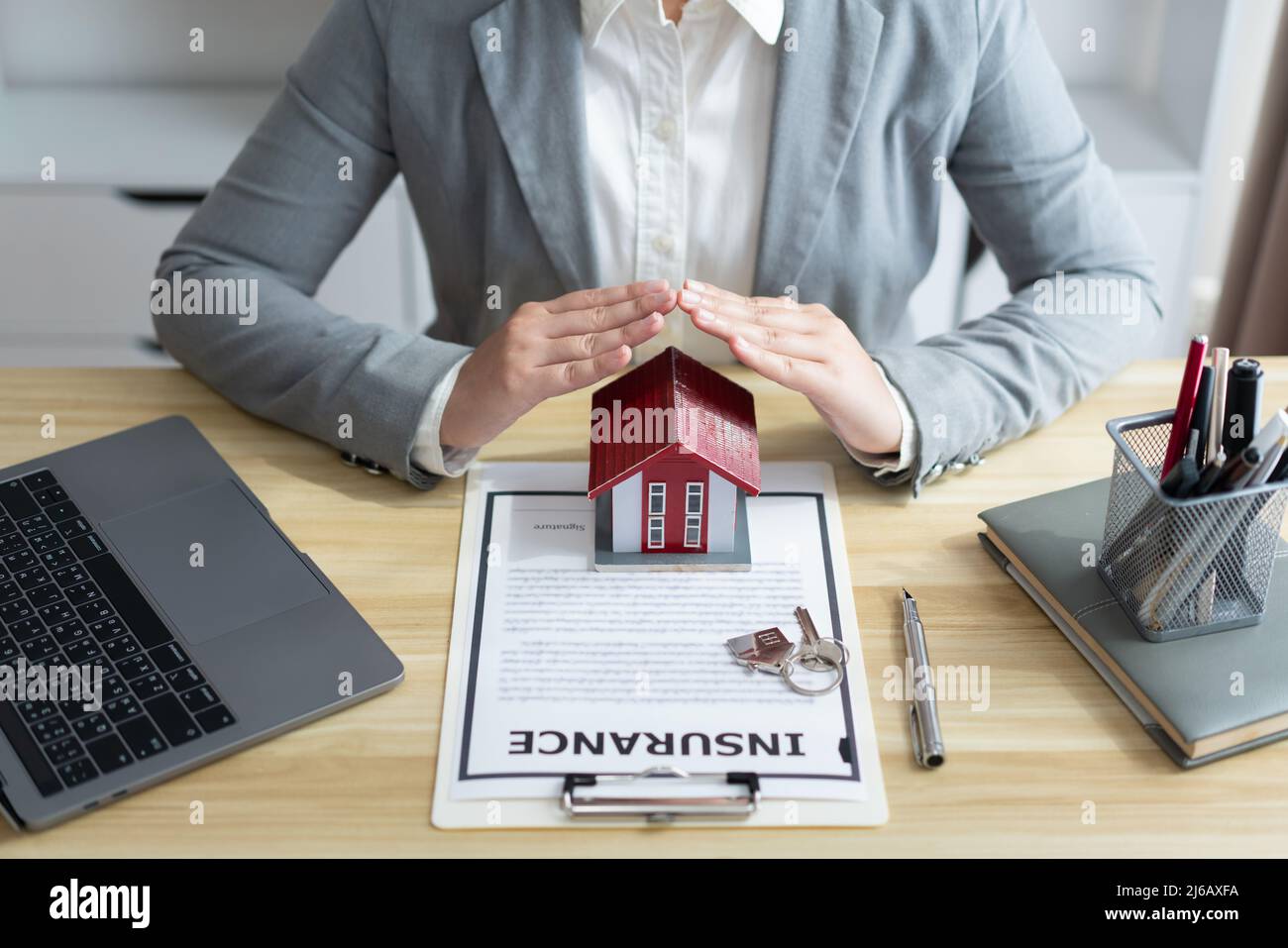 Insurance concept the property dealer presenting the modern model of ...