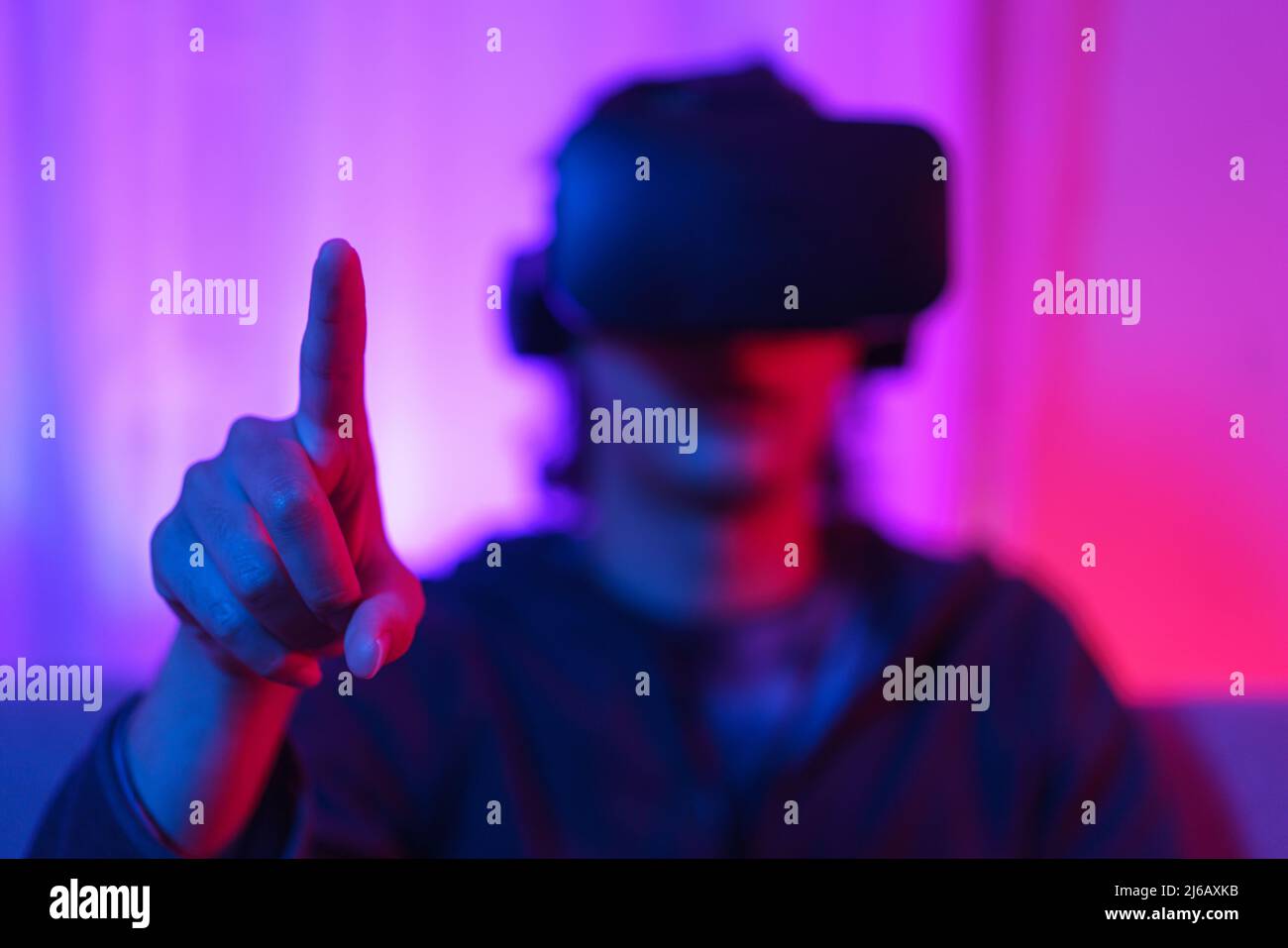 Metaverse technology concept, Man wear VR goggles and pointing to touch ...