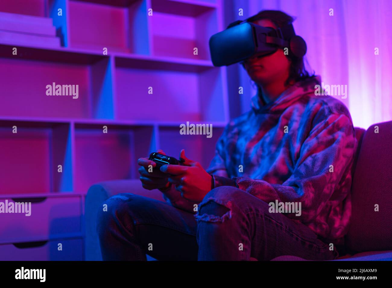 Metaverse technology concept, Man wear VR goggles and use joystick to ...