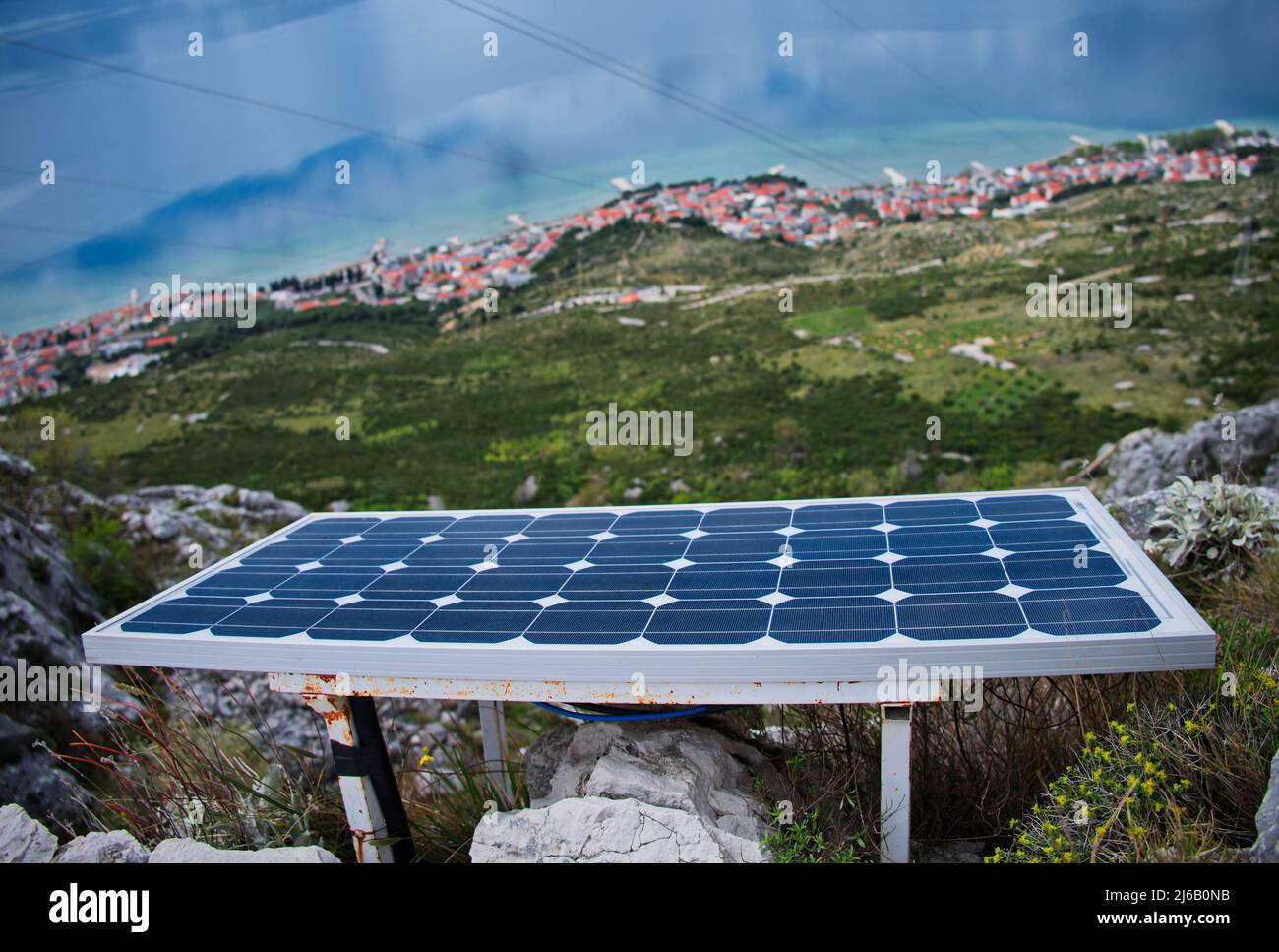 Solar panel on the top of the mountain with townscape in the background ...