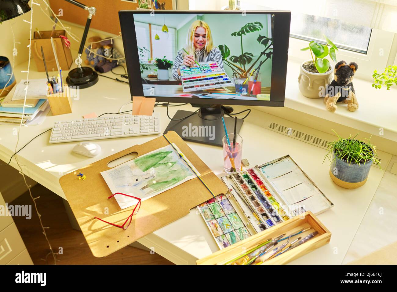 Teenage girl on computer screen teaches to draw Stock Photo - Alamy