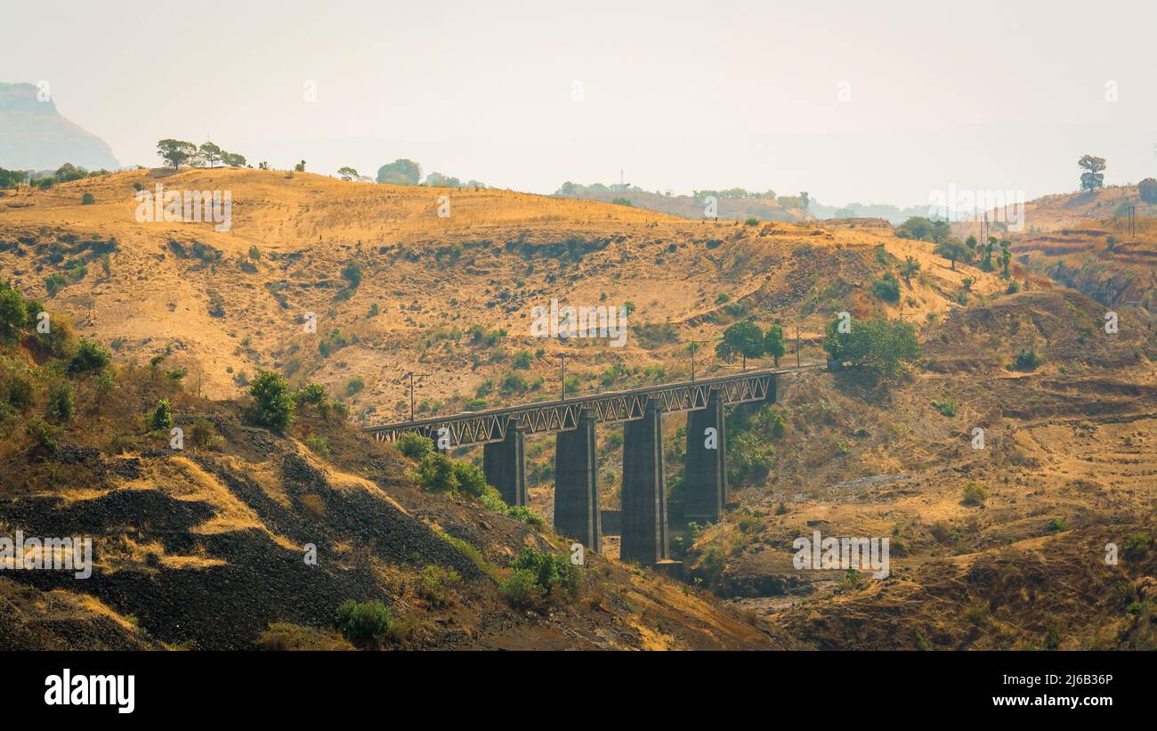 Classic bridge of Indian Railway surrounded by mountains Stock Photo ...