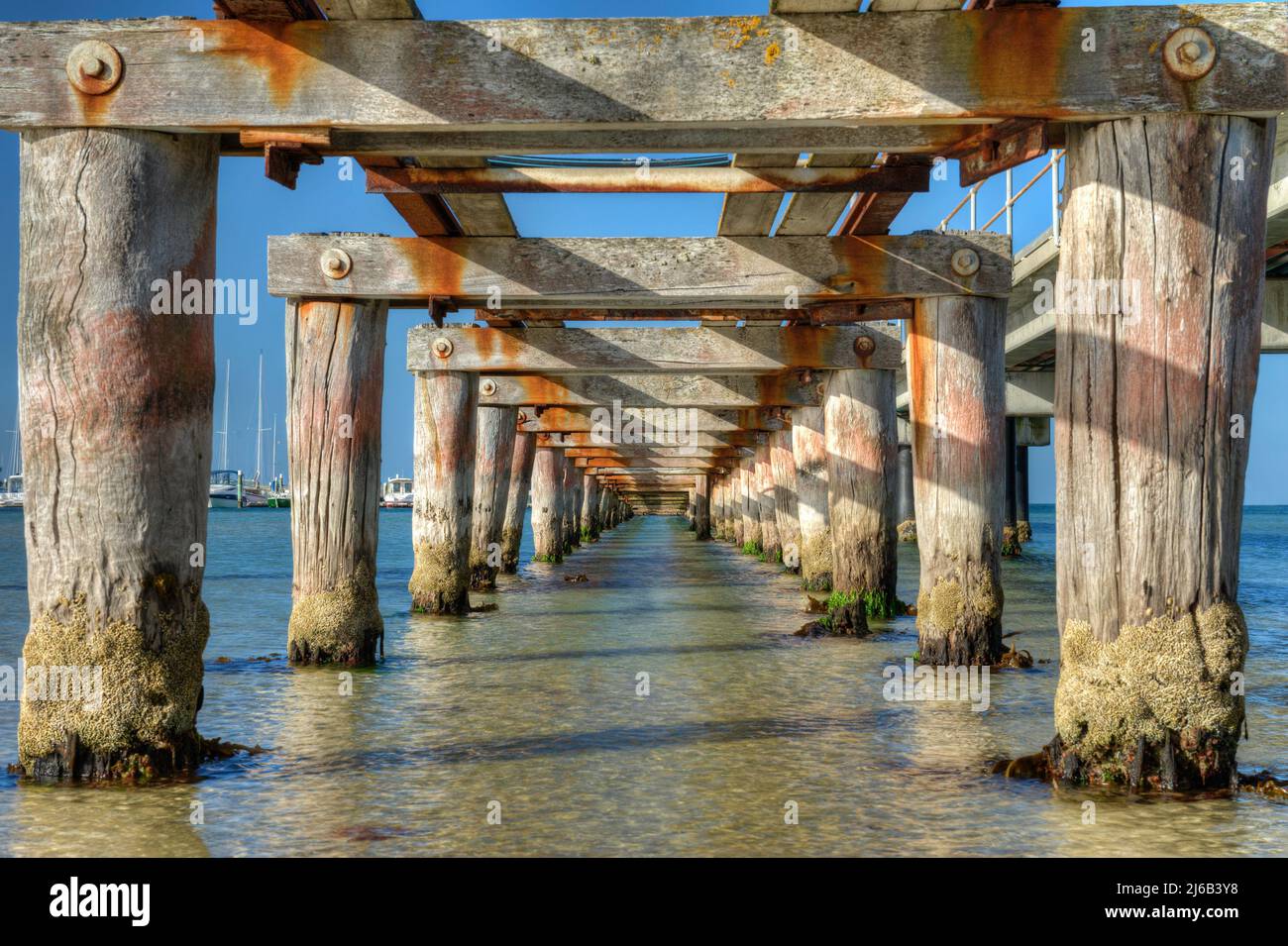 Old wooden pier on the beach hi-res stock photography and images - Alamy
