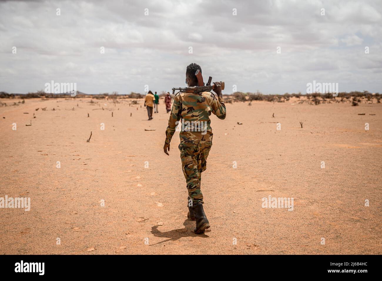 A soldier walks through a camp for displaced people on the outskirts of ...